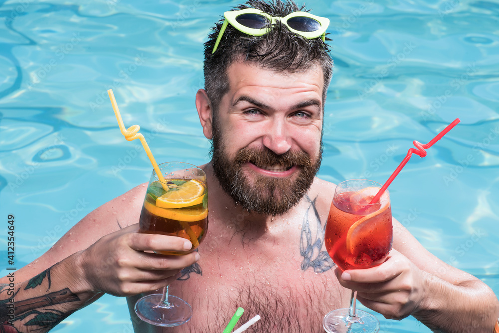Cocktail party with bearded man in pool. Guy swimming and drink ...