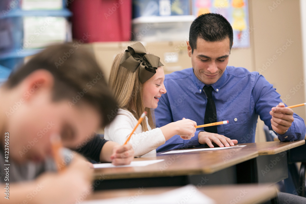 Classroom: Girl Student Gets Help From Teacher Stock Photo | Adobe Stock