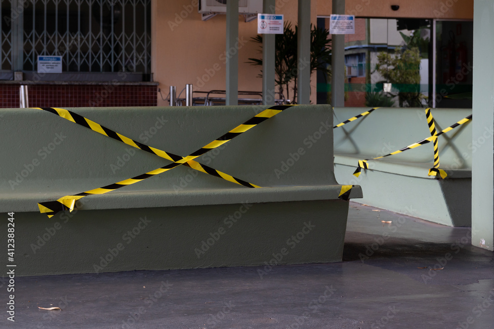 Hospital Reception benches with warning tapes promoting social distance ...