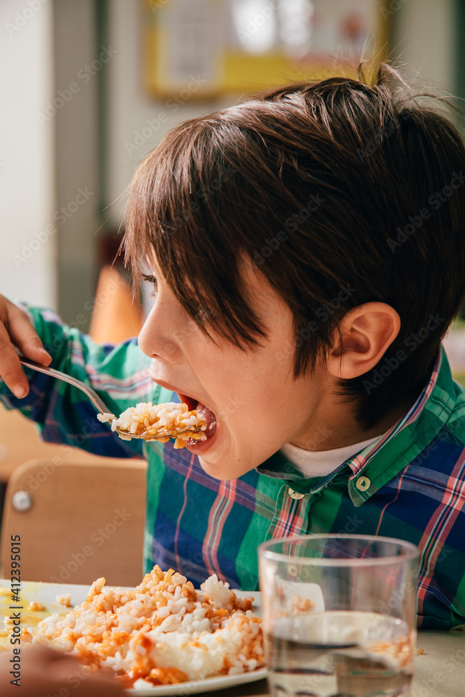 Cute Kid Eating at the School Canteen Stock Photo | Adobe Stock