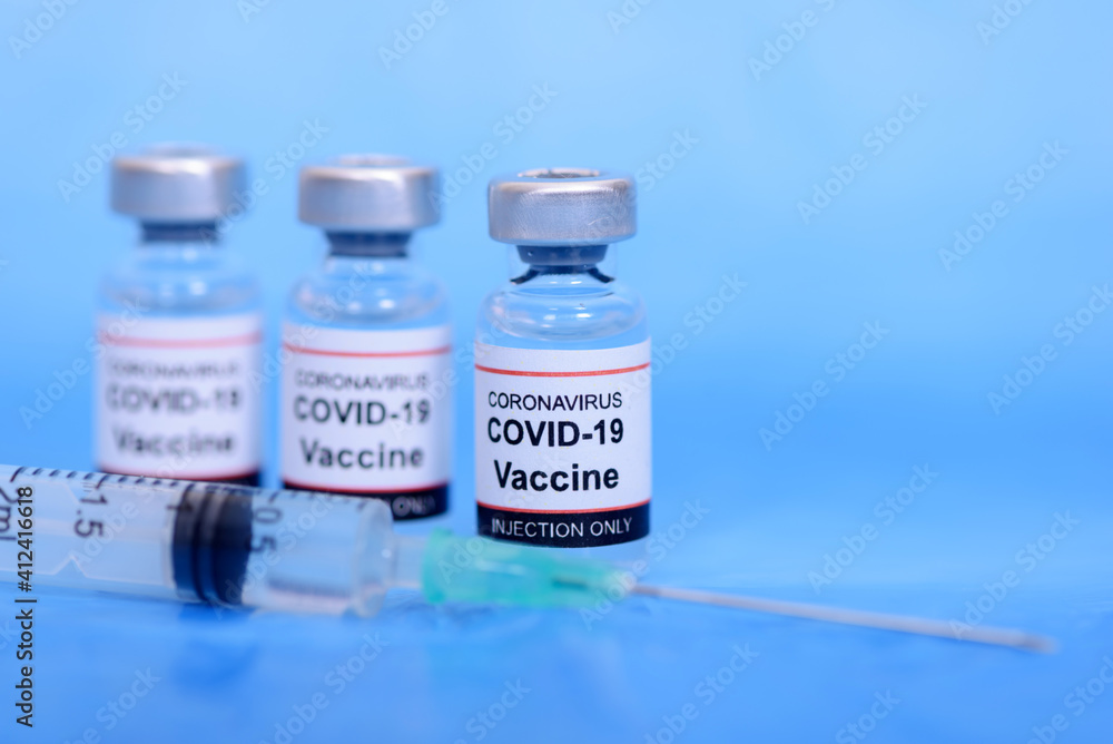 Vaccine and Healthcare Medical concept. Vaccines and syringe on blue ...