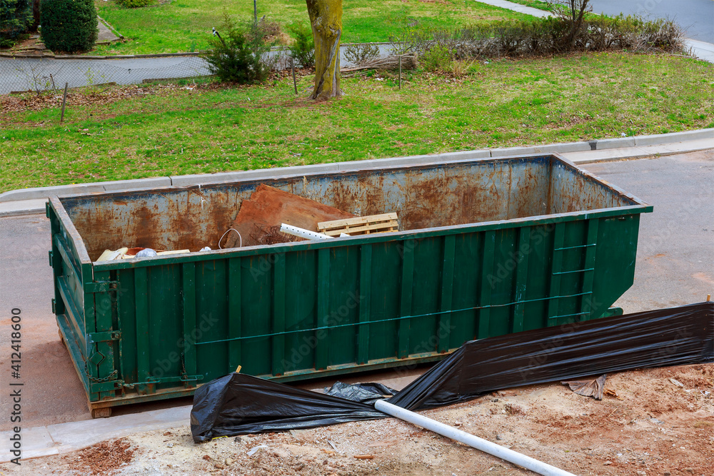 Dumpsters construction garbage a wood frame structure of house under ...