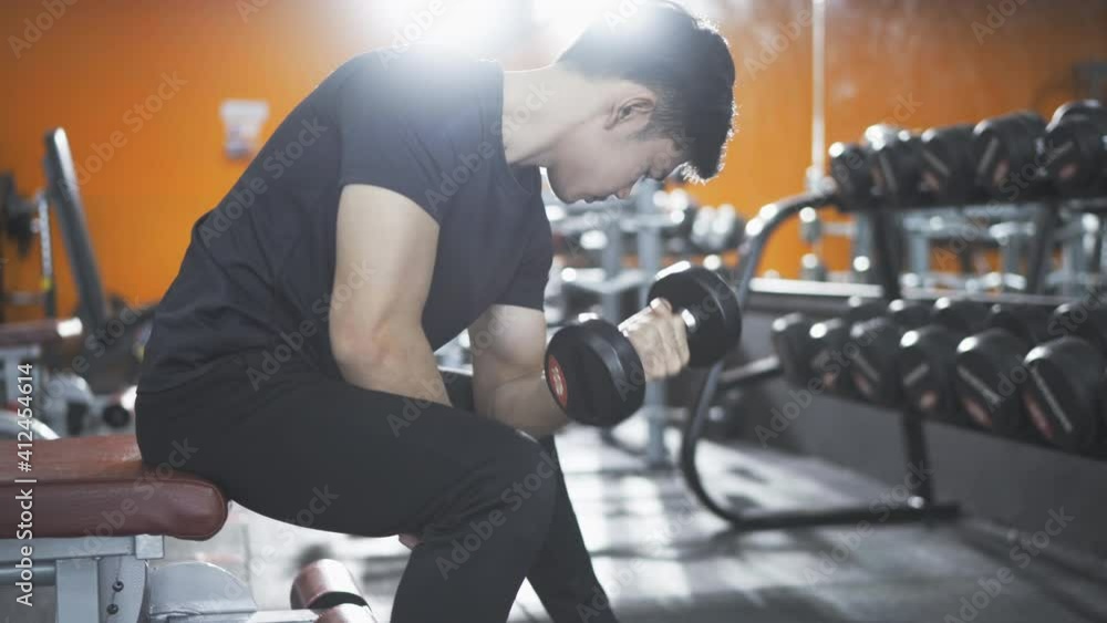 Vidéo Stock strong muscular male bodybuilder trains the triceps, chest ...