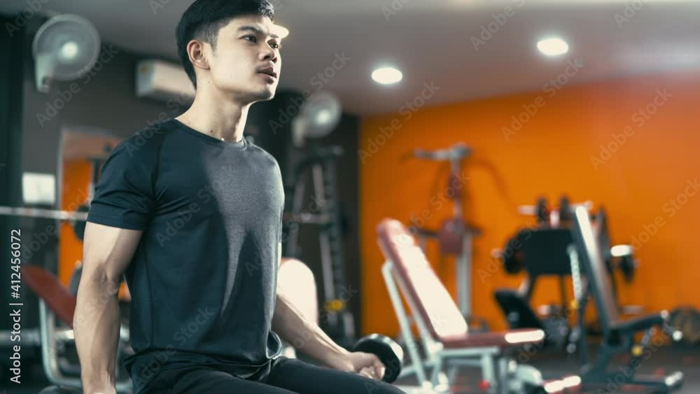 strong muscular male bodybuilder trains the triceps, chest, and delta ...