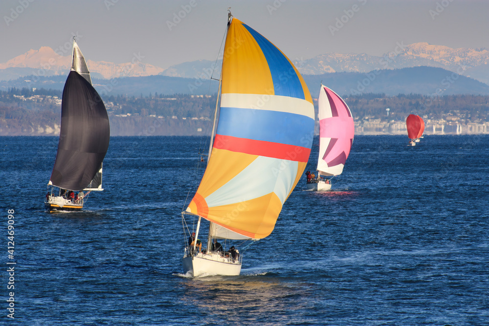 Multiple sailboats racing together towards the finish line in Tacoma's ...