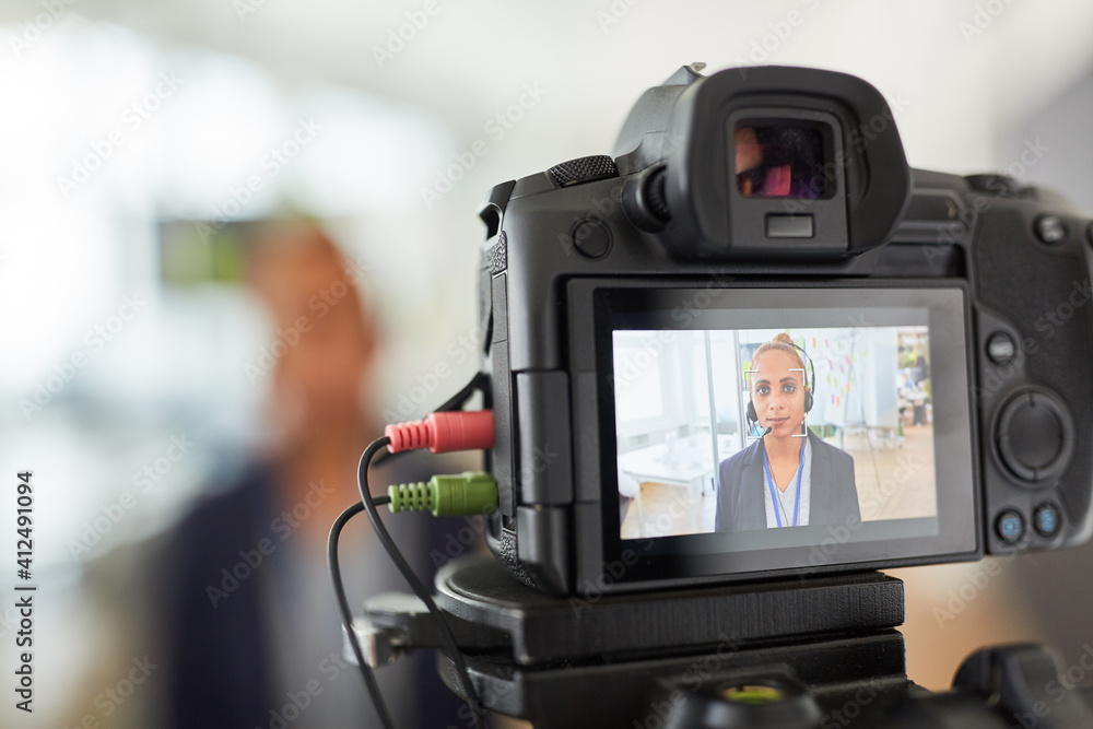 Business woman in front of a video camera Stock Photo | Adobe Stock