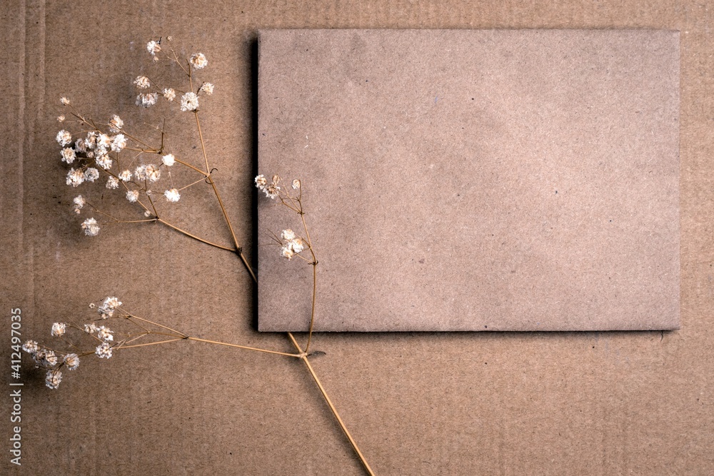 Rectangular template envelope from old paper and a sprig of dried ...