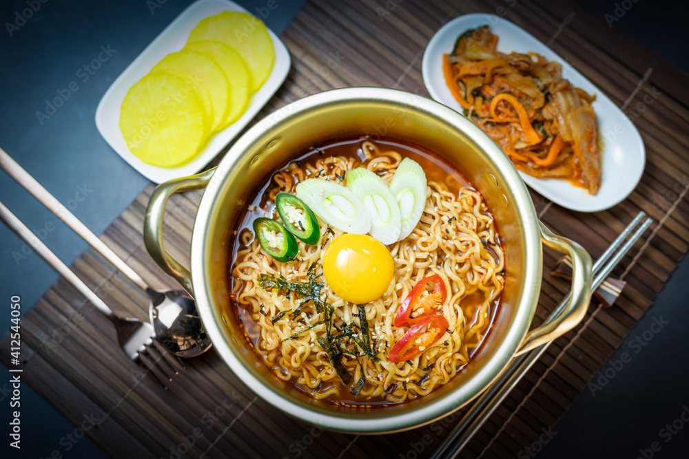 Korean traditional Ramyeon noodle with egg yolk, chilli, kimchi in a ...
