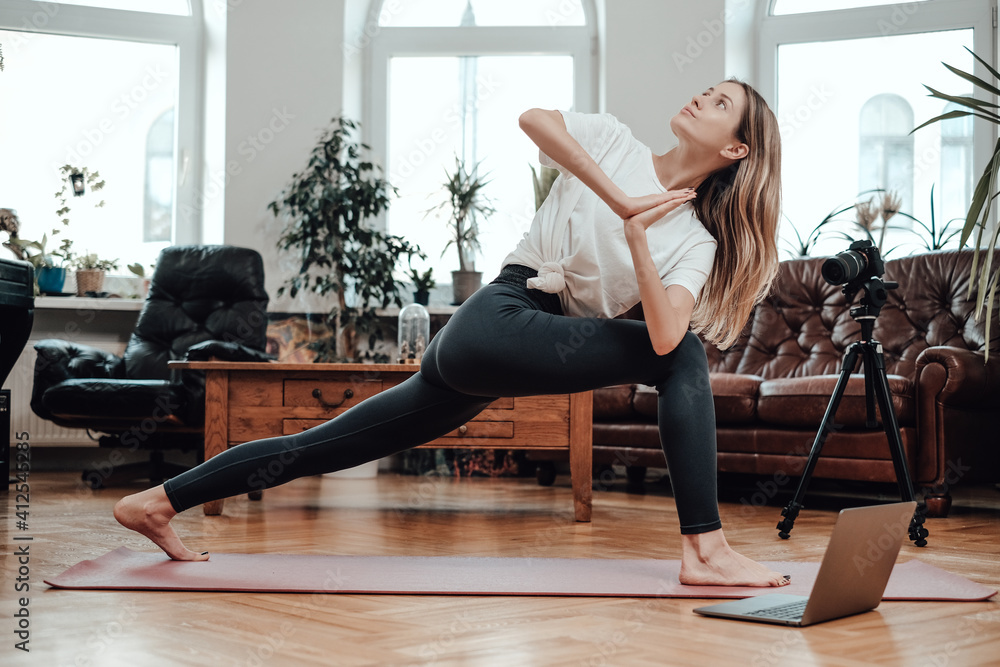 Portrait of female yoga coach which shows some postures and streams her ...