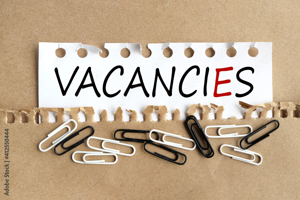 vacancies.text on white paper over torn paper background. Stock Photo ...