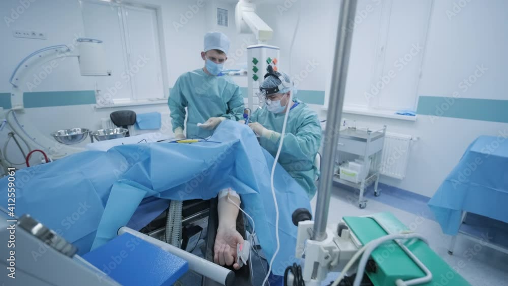 Operation of removing tonsils under deep anesthesia, surgeon uses ...