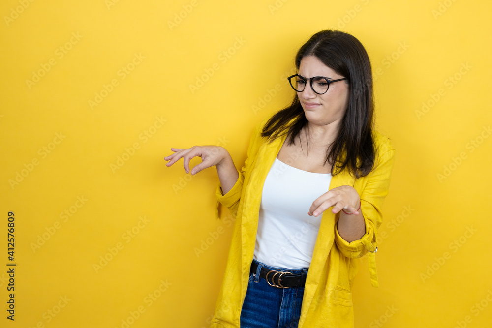 Young brunette businesswoman wearing yellow blazer over yellow ...