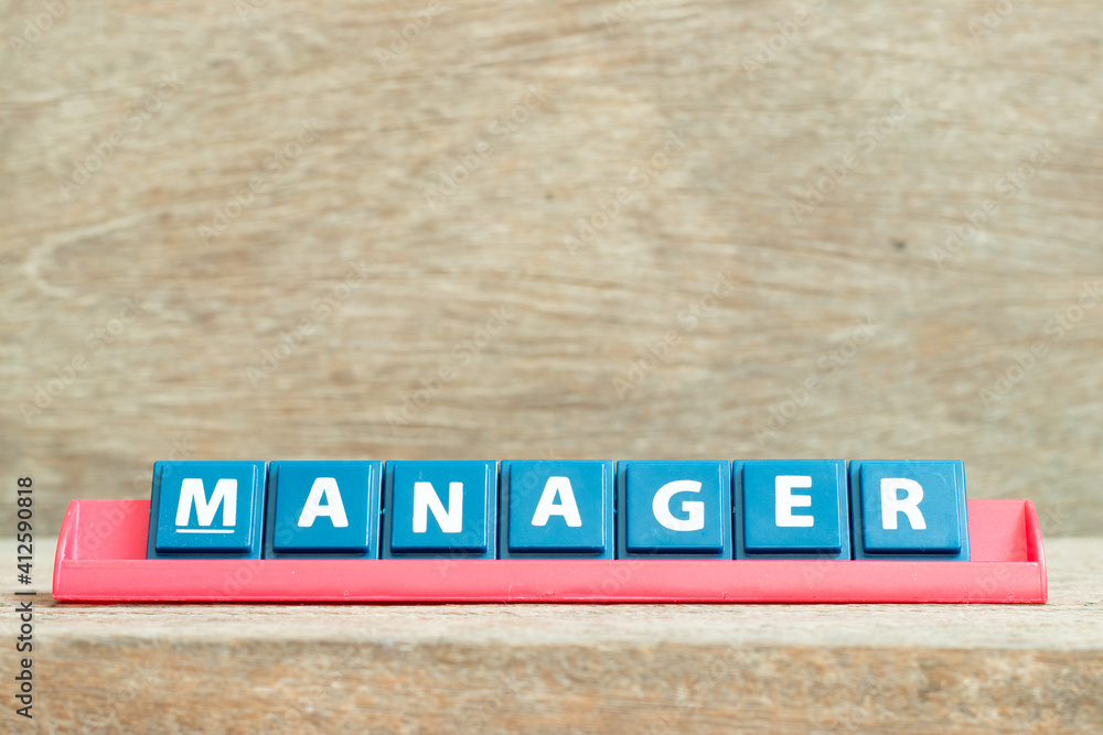 Tile alphabet letter with word manager in red color rack on wood ...