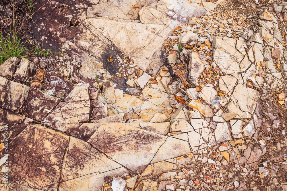 Sedimentary rock. Sedimentary rocks broken on pieces on the ground ...