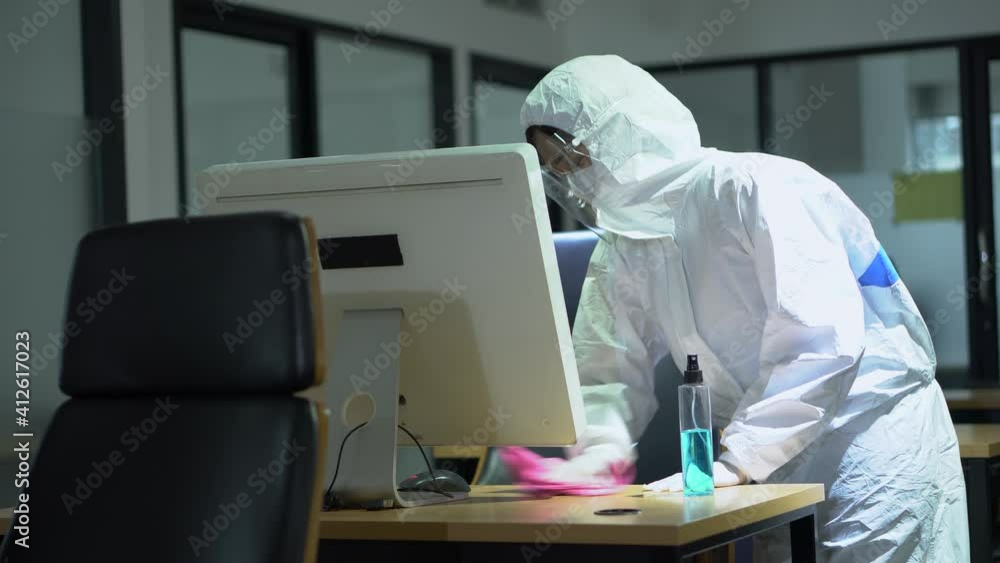 Specialist wearing ppe suit using alcohol sanitizer spray to cleaning ...