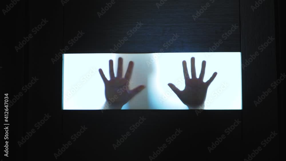 Possessed boy scratching glass with hands, creepy female silhouette ...