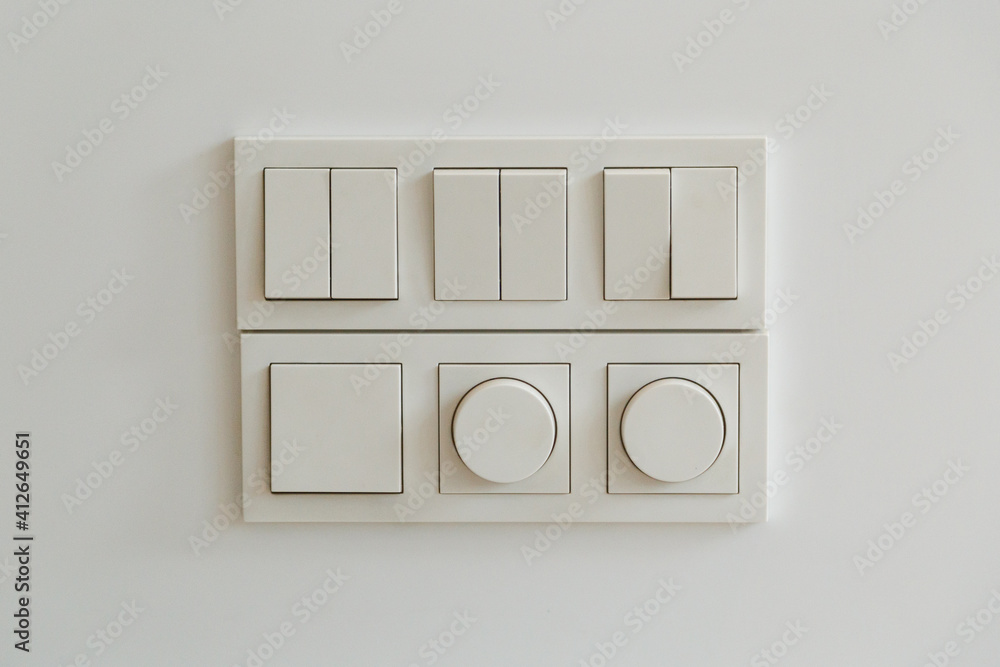 multiple light switch, white plastic mechanical switch mounted on a ...