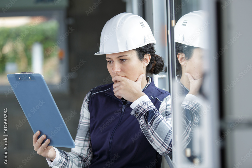 serious female building inspector looking at ceiling ภาพถ่ายสต็อก ...