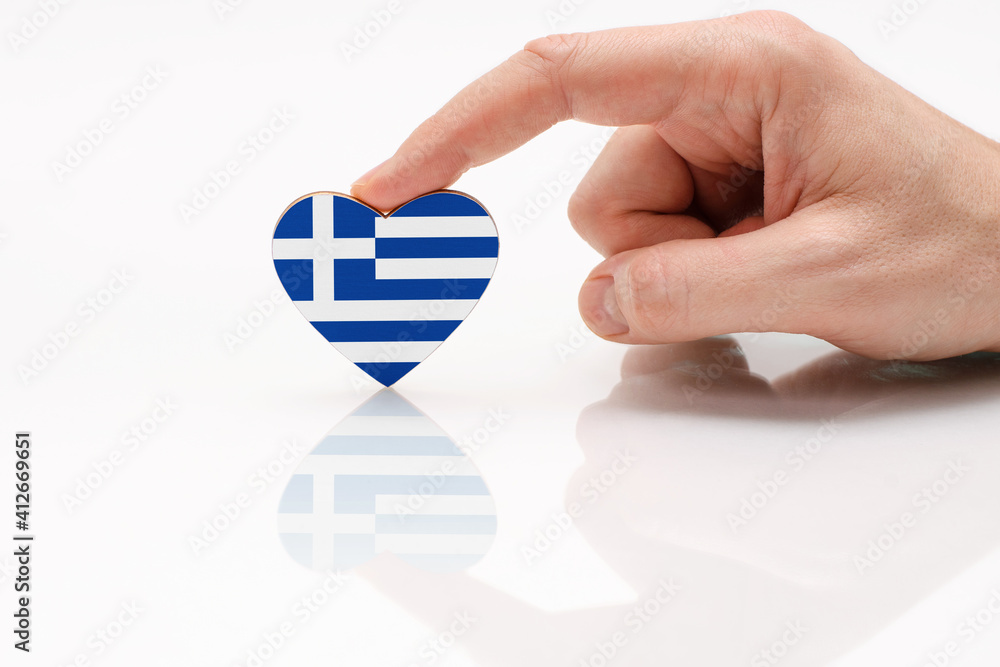 Love and respect Greece. A man's hand holds a heart in the shape of the ...