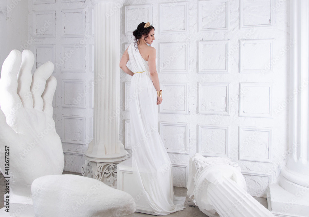Beautiful Greek goddess woman close up among the white ancient ruins ...