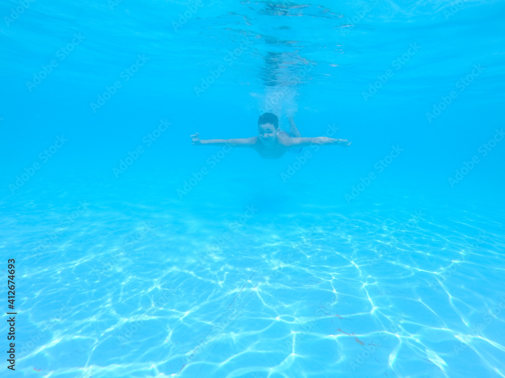 boy swimming in pool with blue water in vacation Stock Photo | Adobe Stock