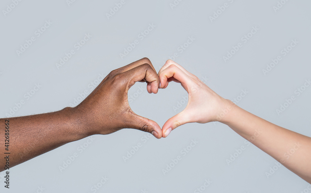 People different skin colors put their hands together making heart ...