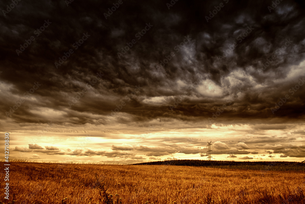 Beautiful scenery of a dry grassy field under dark storm clouds Stock ...