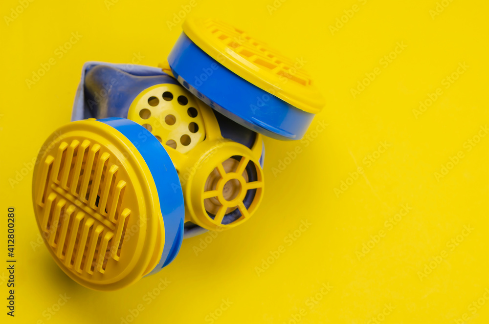 Respirator type half mask with replaceable filters on yellow background ...