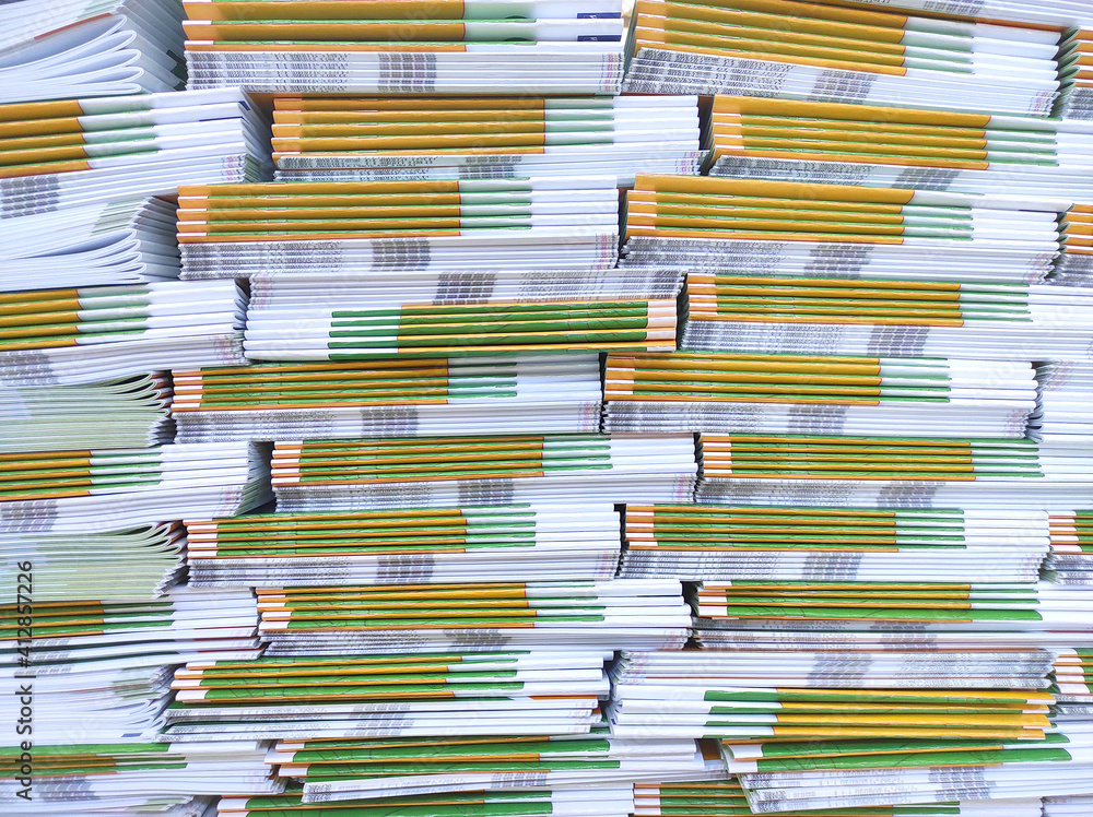 Lot of books stacked in layers in huge endless wall of knowledge ...