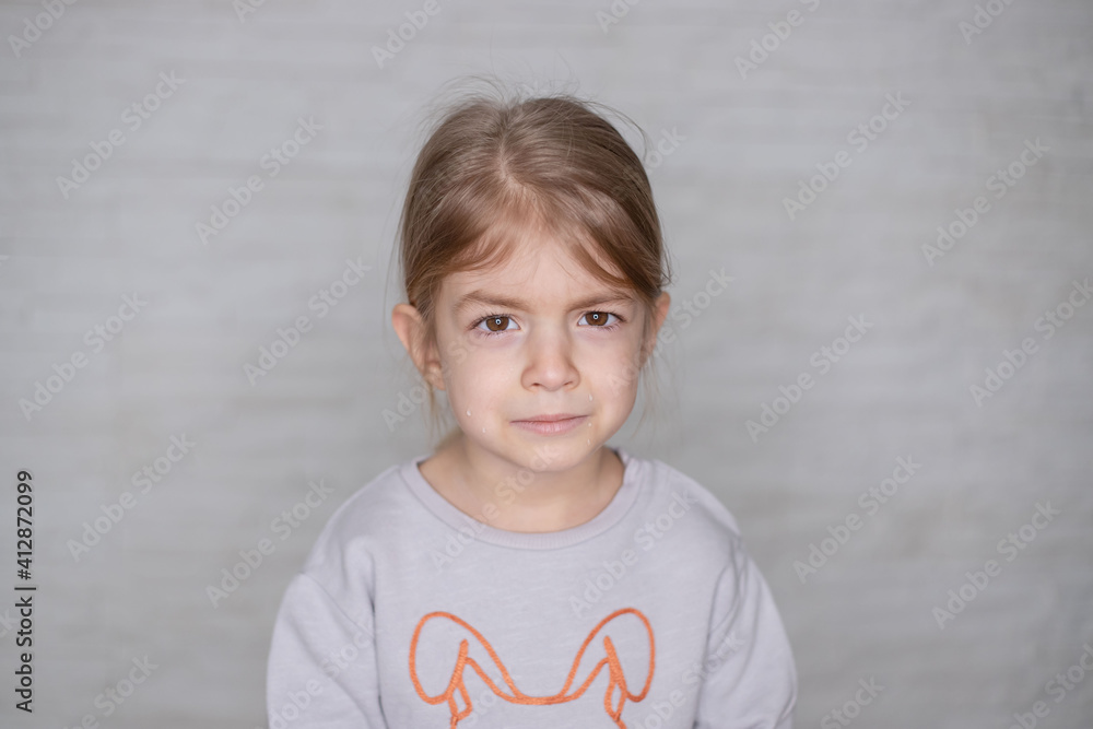 Little girl with sad expression and tears. Portrait of bored and crying ...