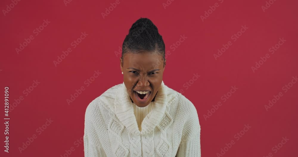 Female mad scream. Closeup of face of furious afro american woman ...