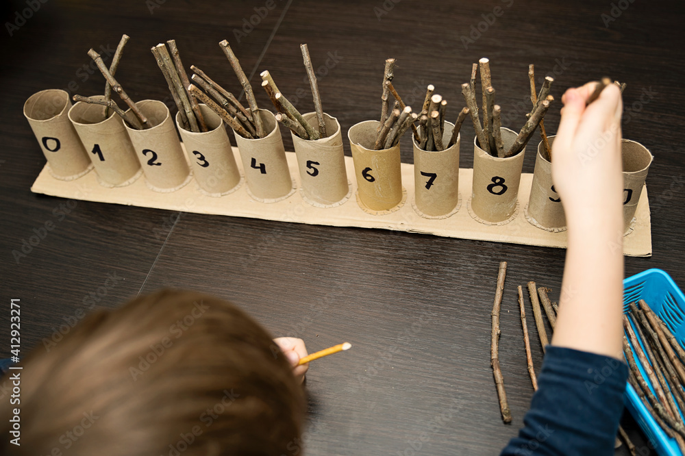 Little child doing simple math exercises. Early education, counting ... Little child doing simple math exercises. Early education, counting ...
