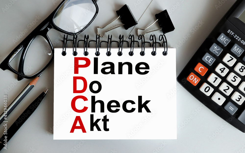 PDCA - Plan Do Check Act. text on white paper on gray background Stock ...