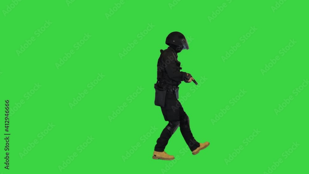 Police SWAT armed fighter walking with a hand gun on a Green Screen ...