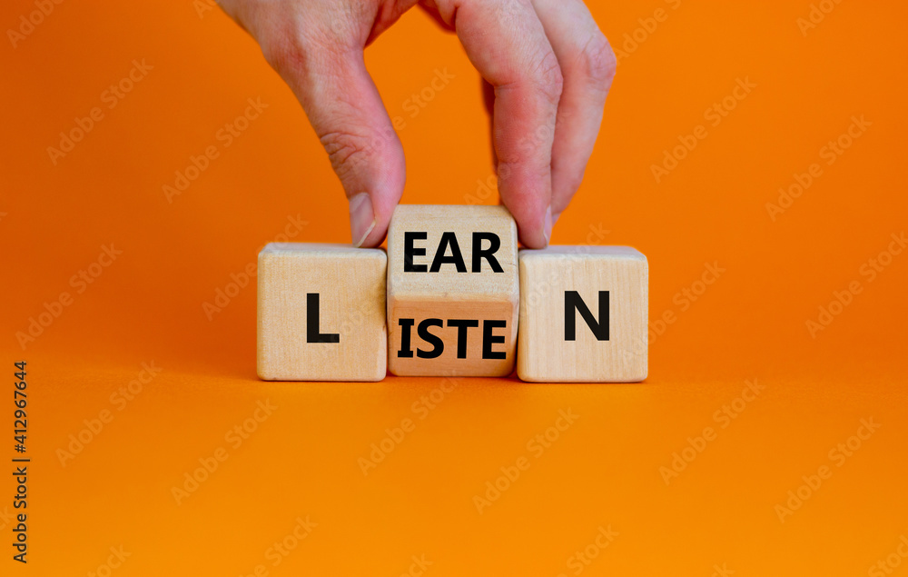 Listen and learn symbol. Businessman turns a wooden cube and changes ... Listen and learn symbol. Businessman turns a wooden cube and changes ...