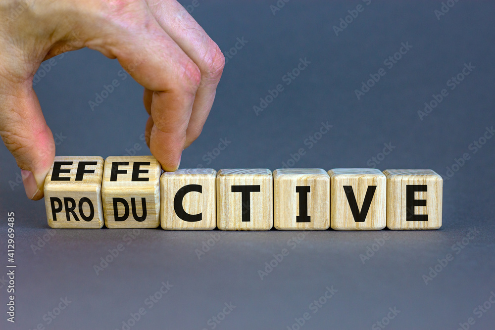 Effective and productive symbol. Businessman turns wooden cubes and ...