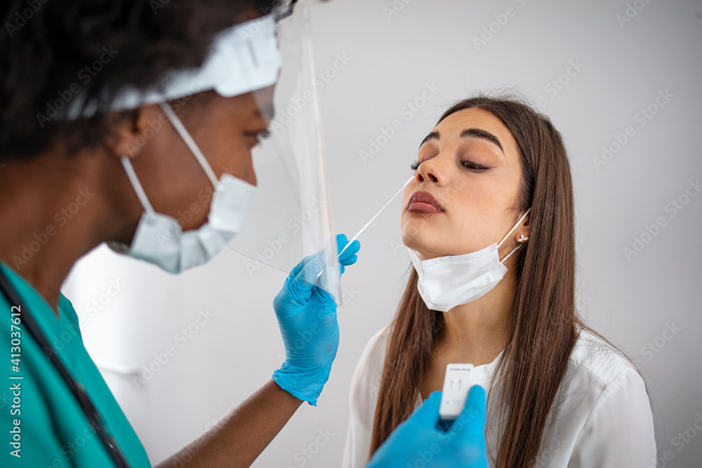 Close-up of a woman having PCR test at medical clinic. Close-up of ...