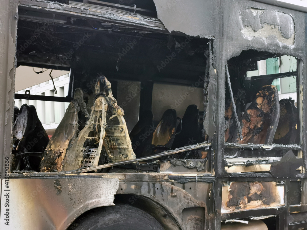 Burnt public traffic bus is seen on the street after caught in fire ...