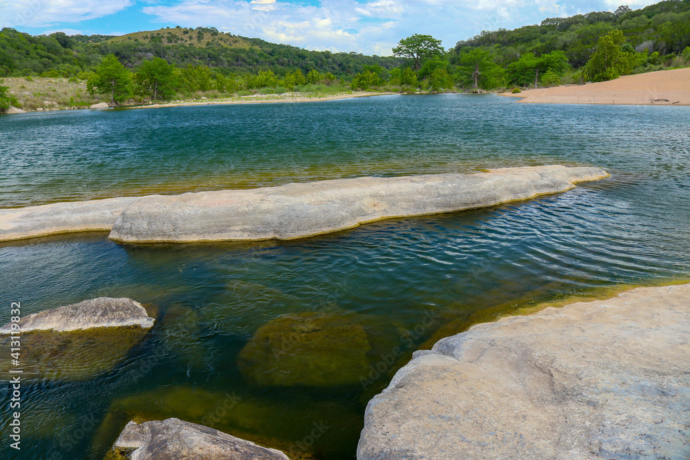 The Pedernales river flows over geological rocks creating pools of ...