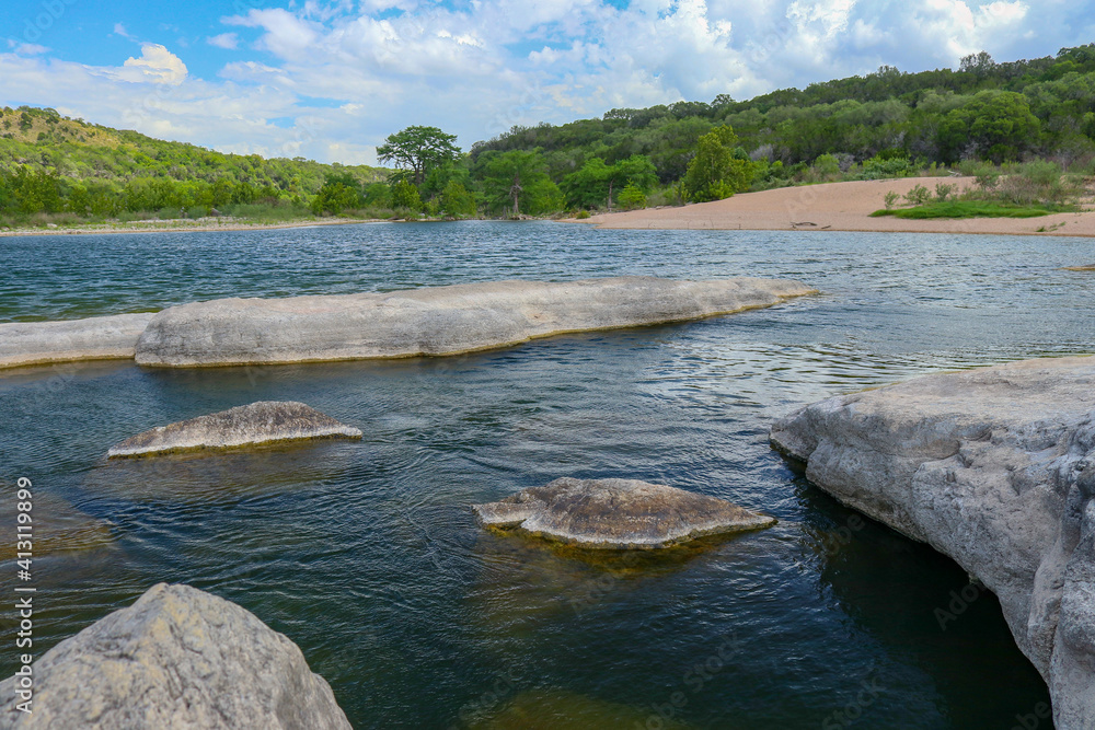 The Pedernales river flows along the limestone rock formations creating ...