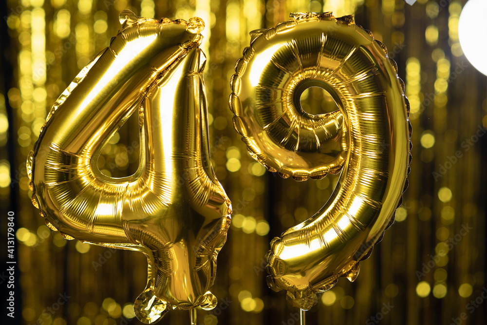 The golden number 49 forty nine one is made of an inflatable balloon on ...