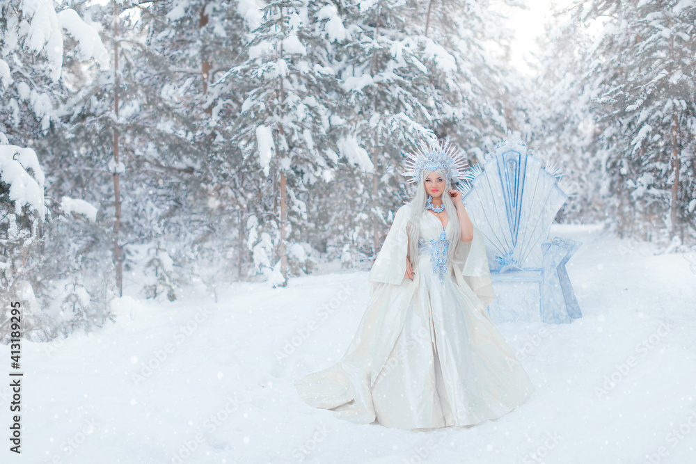 Young girl snow queen in the forest. The crown of the snow queen, the ...