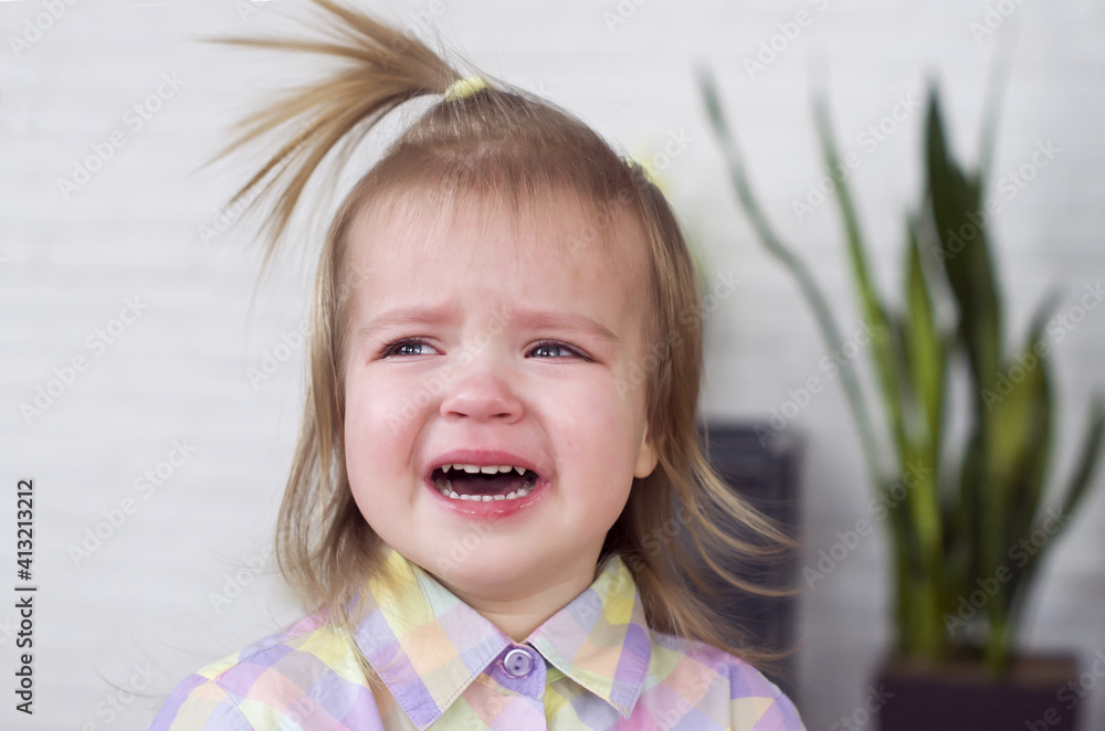 Sad little girl toddler crying. Lonely and unhappy baby girl with funny ...