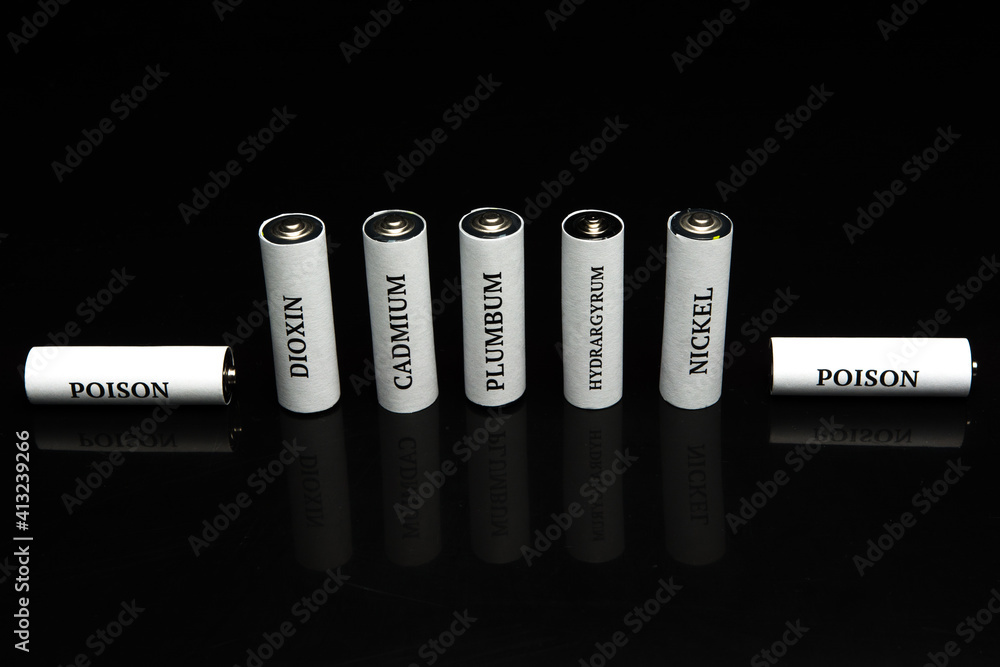 Battery on a black background. Ecology. Harm to nature from batteries ...