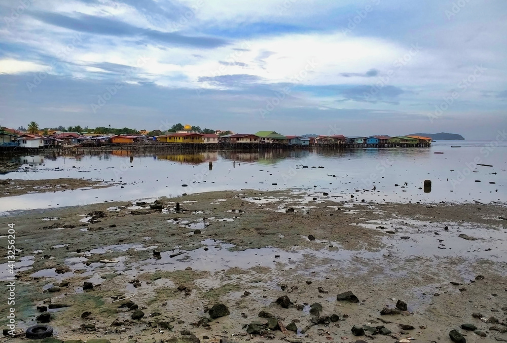 Low tide and houses on the water. Stilt villages in slums. Kota ...