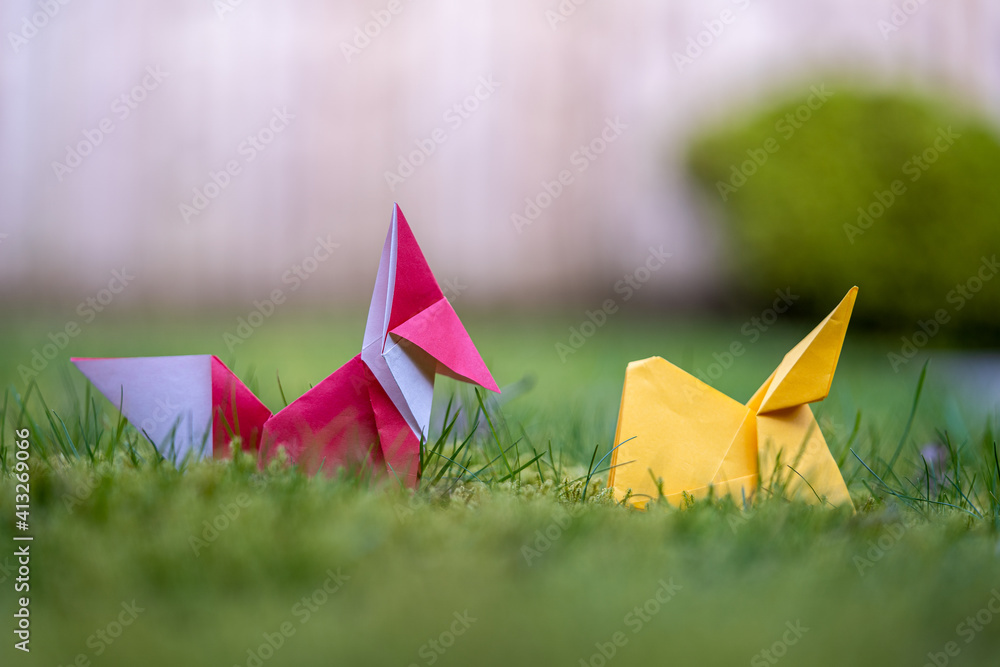 Origami Fox chasing a Rabbit through the long grass outside in the park ...