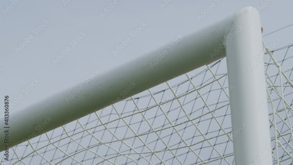 Slow-motion of a football soccer goalkeeper missing the ball for a goal ...