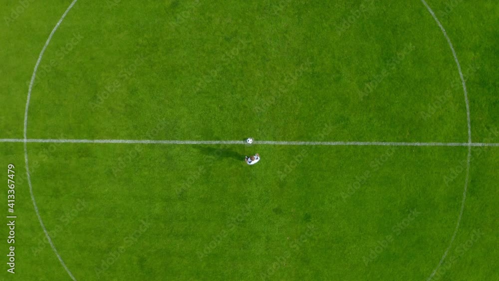 Drone footage of a professional football soccer player at the center ...
