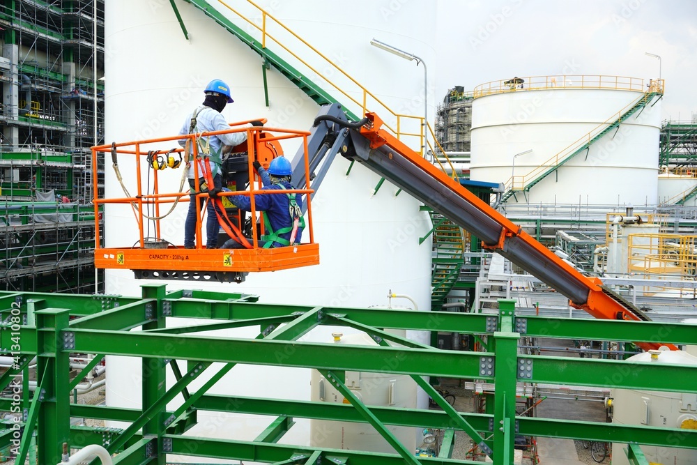 Poster Worker are driving the Orange articulate boom lift or telescopic ...