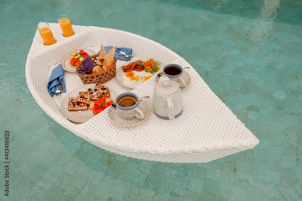 Floating breakfast set in tray with fried egg, waffles bread , fresh ...
